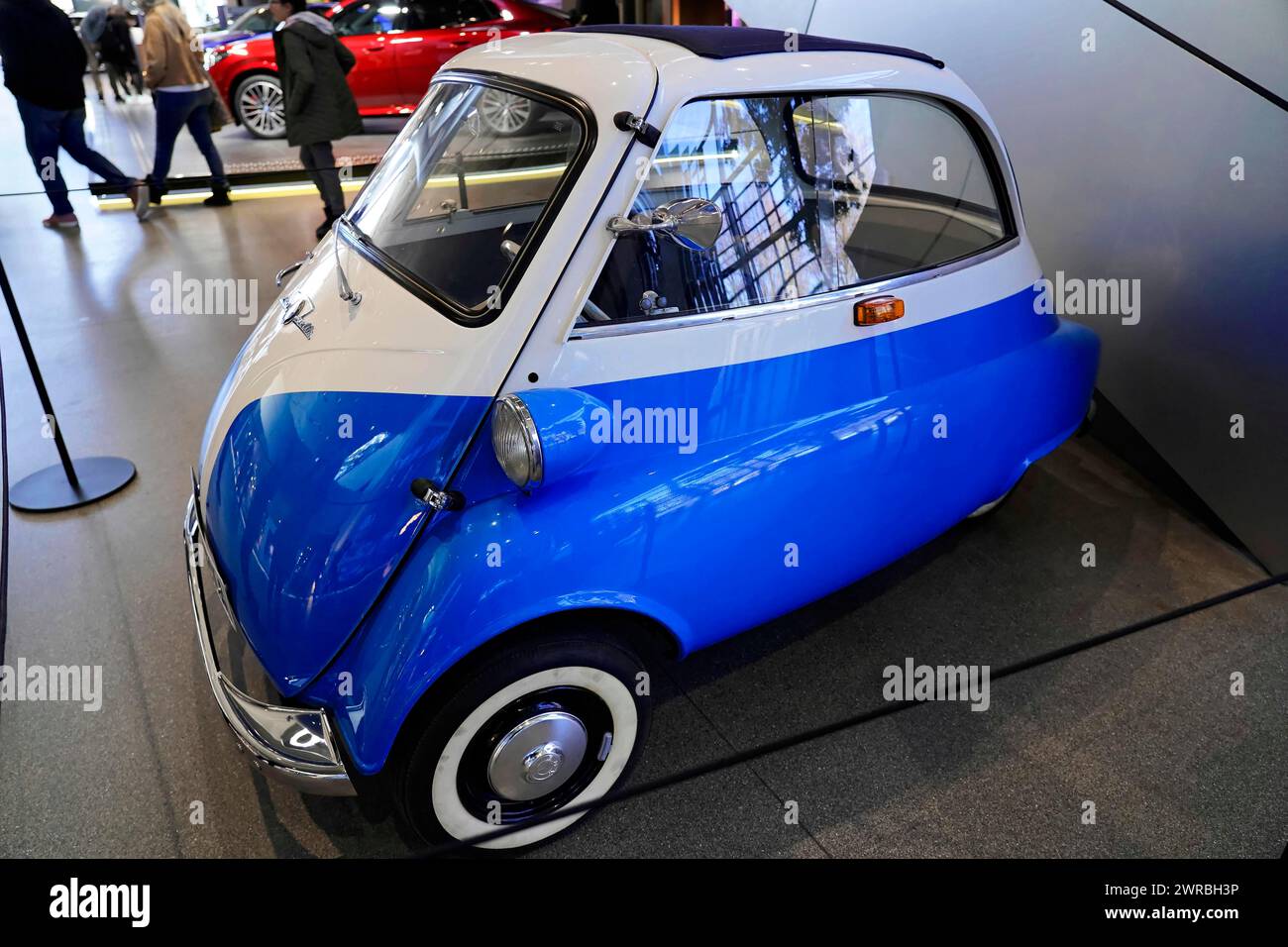 A classic blue and white small car presented in an exhibition hall, BMW ...