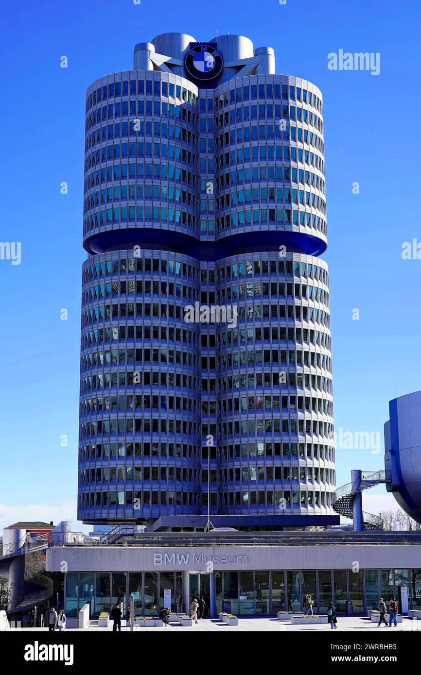 Four cylindrical towers of the BMW building under a bright blue sky ...