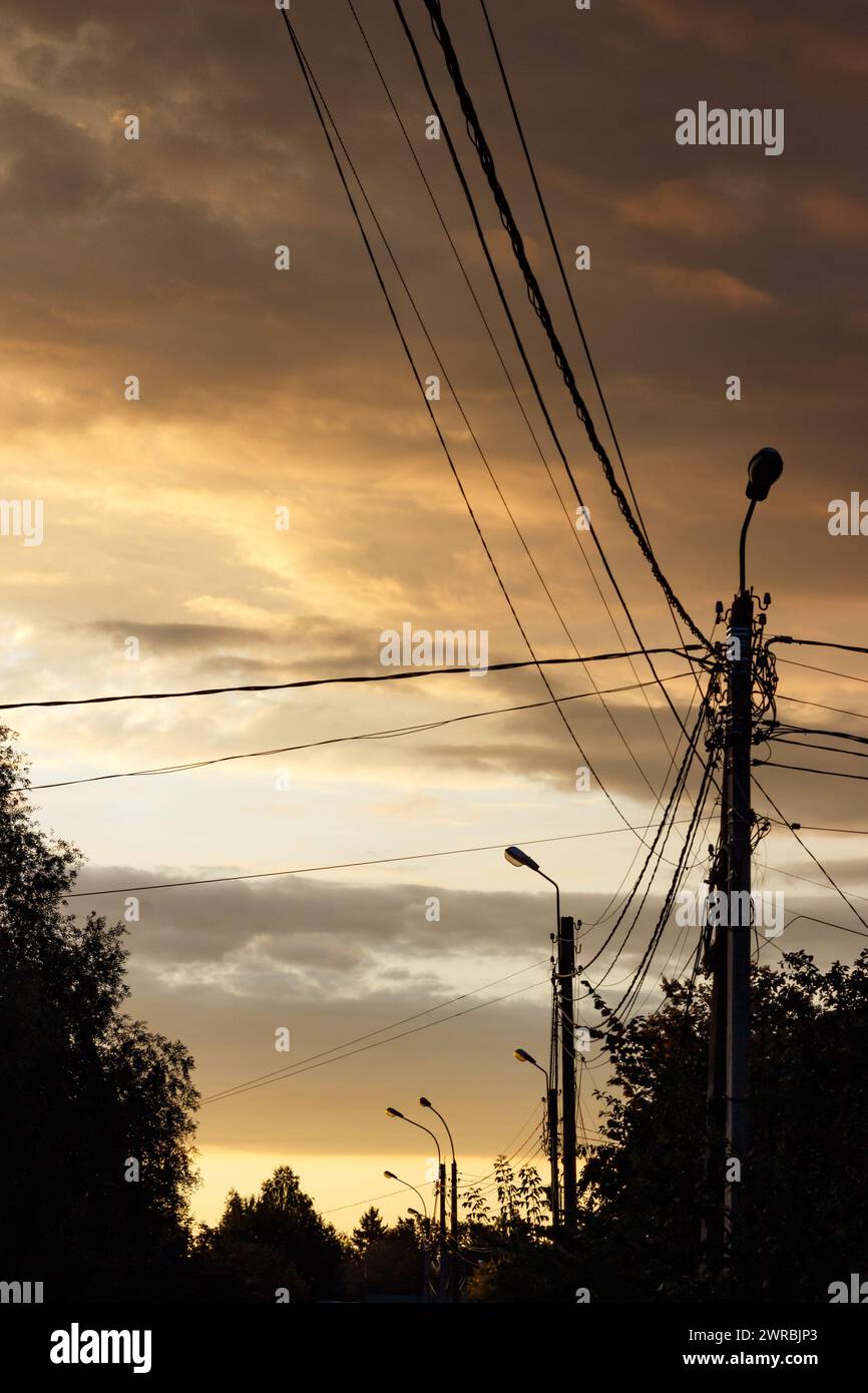 Vertical view of electrical wires hanging on poles Stock Photo - Alamy