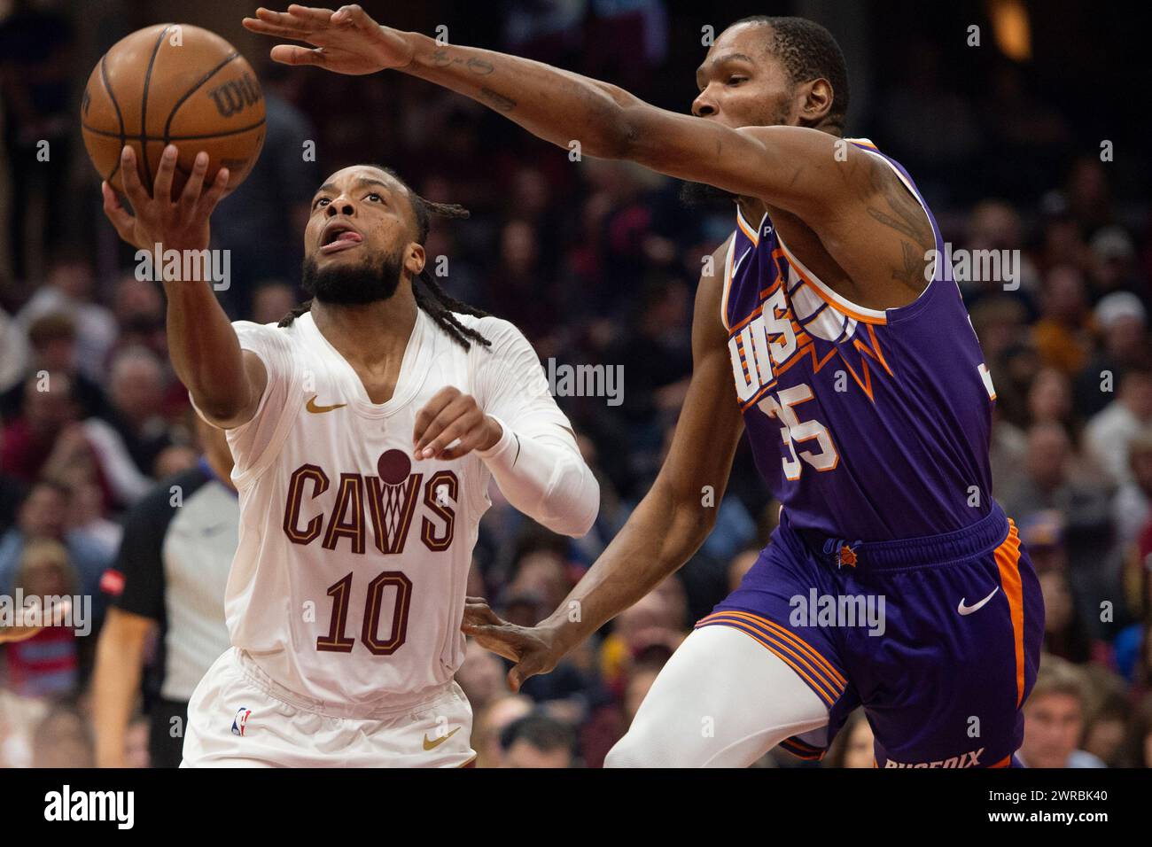 Cleveland Cavaliers' Darius Garland (10) shoots under the arm of ...