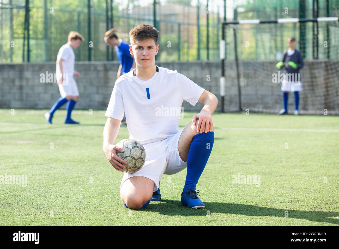 Youth football player sitting hi-res stock photography and images - Alamy