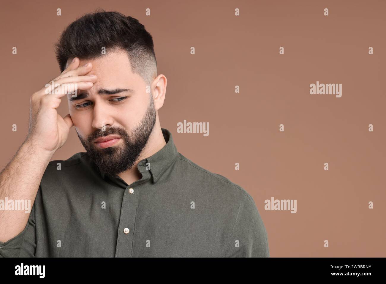 Portrait of sad man on brown background, space for text Stock Photo - Alamy