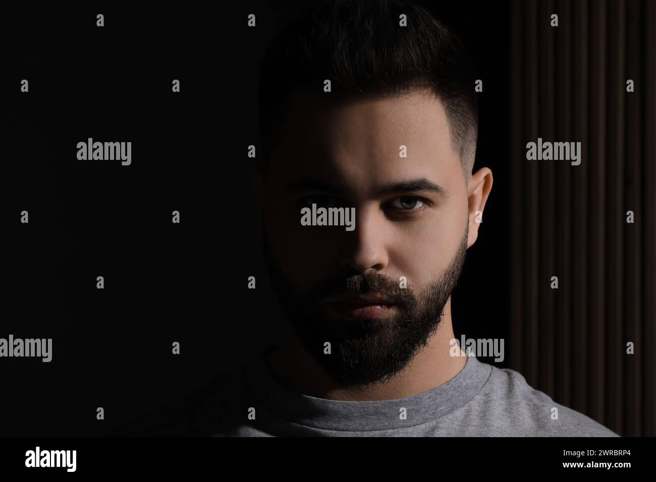 Evil eye. Man with scary eyes on black background, space for text Stock ...