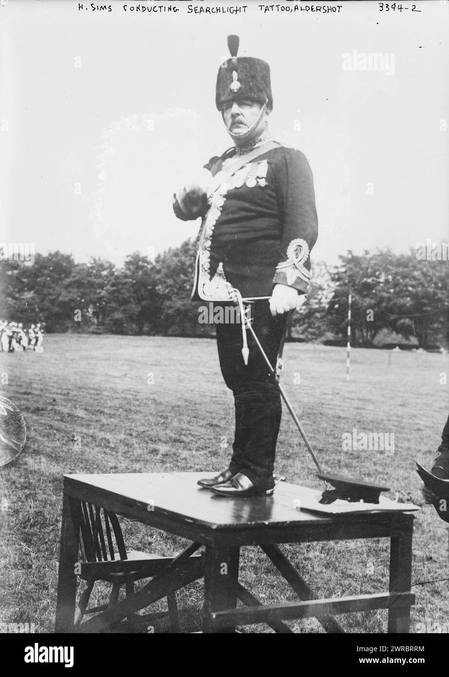 H. Sims conducting searchlight tattoo, Aldershot, Photograph shows H ...