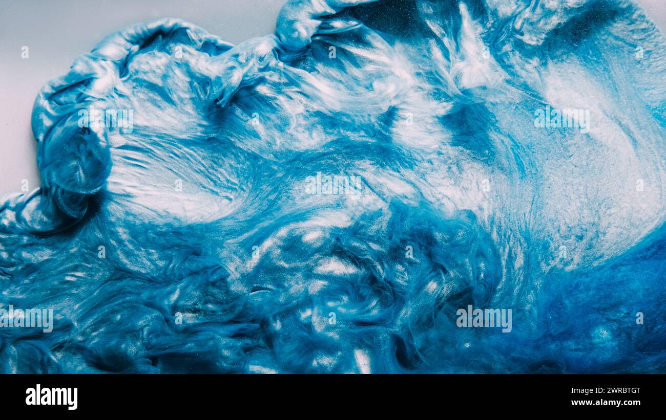 Ink water splash paint flow blue shiny fluid drop Stock Photo - Alamy
