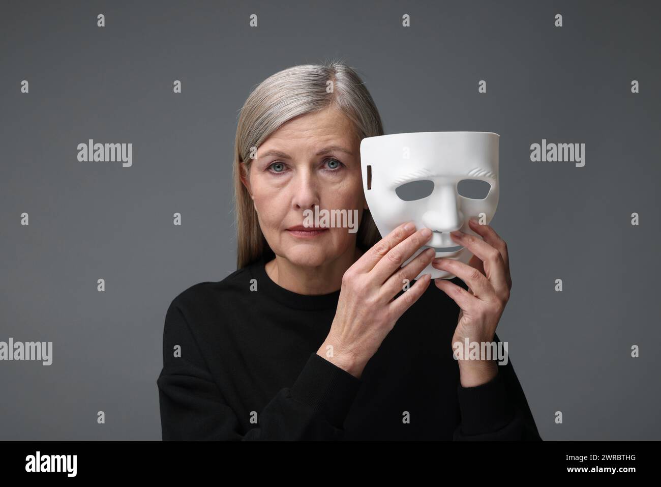 Multiple personality concept. Woman with mask on gray background Stock ... Multiple personality concept. Woman with mask on gray background Stock ...