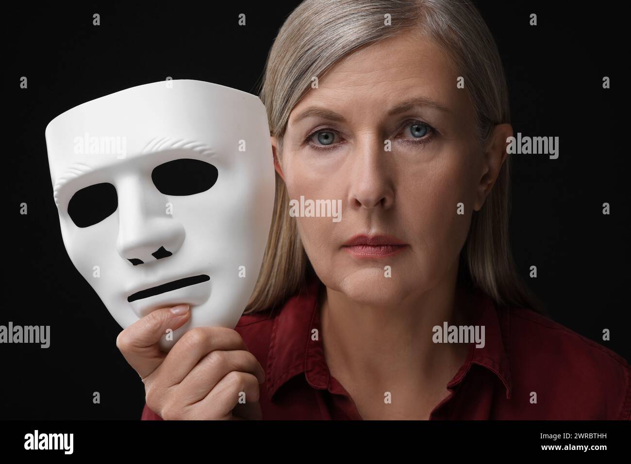 Multiple personality concept. Woman with mask on black background Stock ...