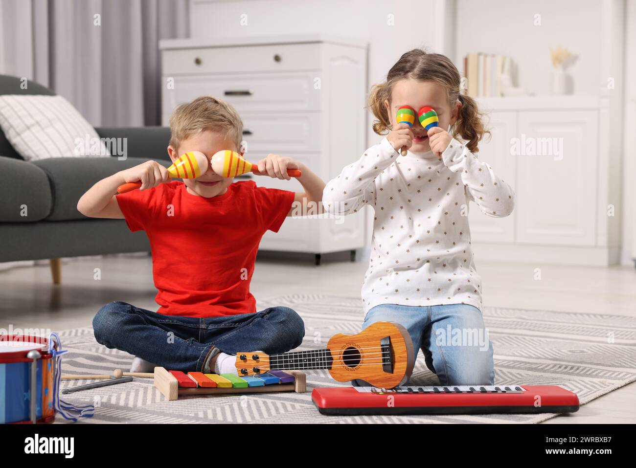 Little children playing toy musical instruments at home Stock Photo - Alamy