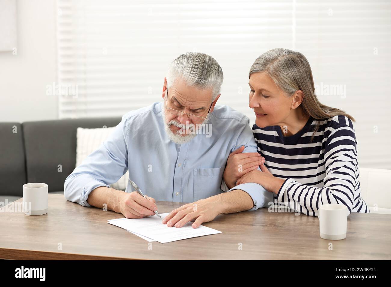 Senior couple signing Last Will and Testament indoors Stock Photo - Alamy