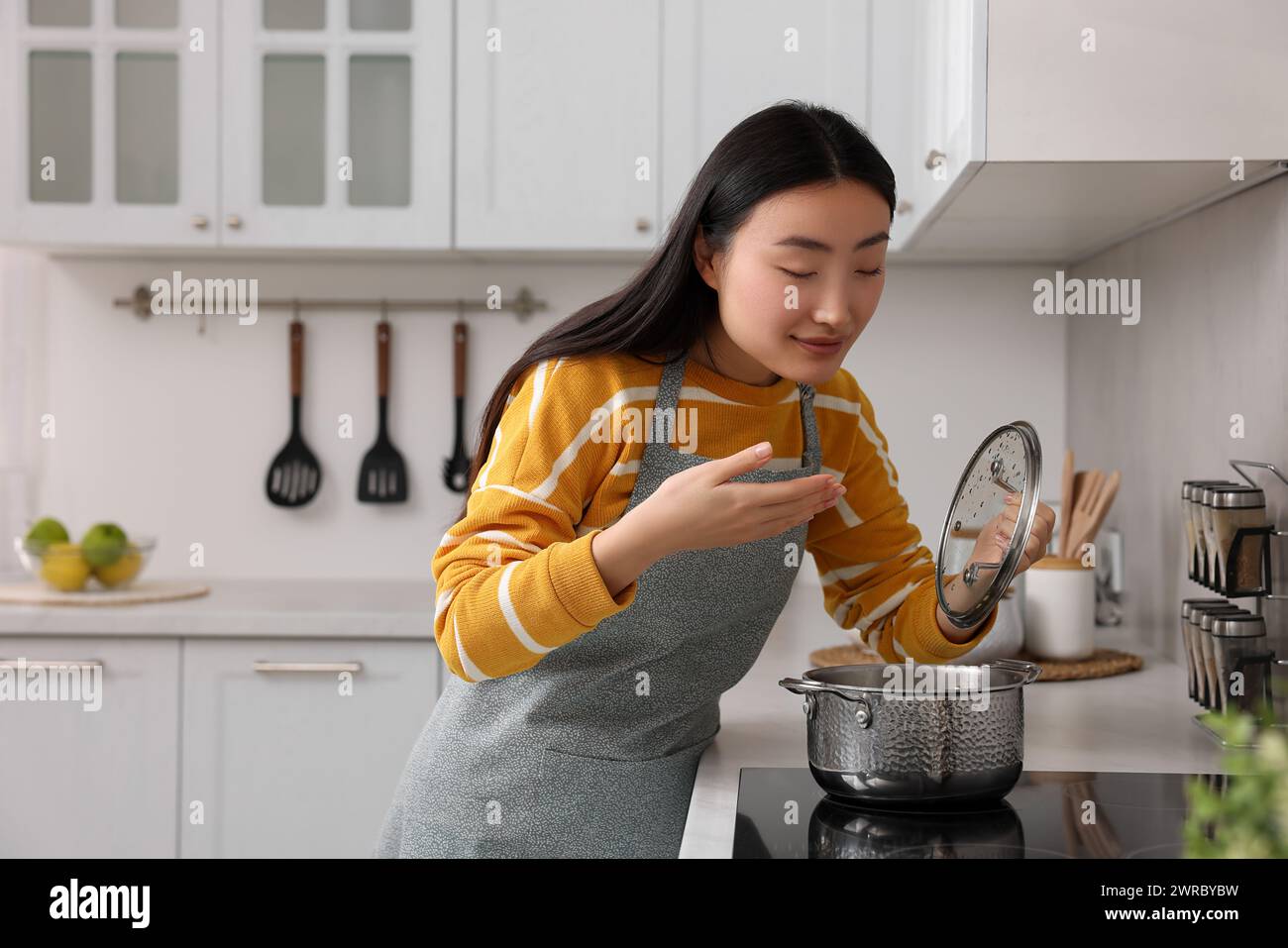 Young woman smelling food cooking hi-res stock photography and images ...