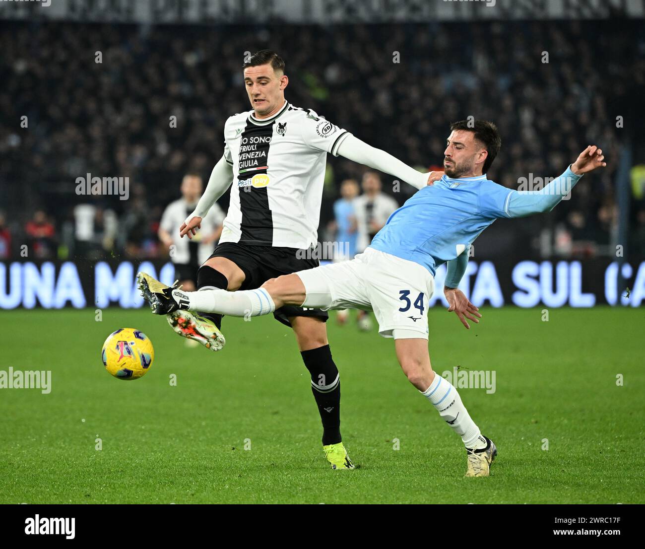 Rome, Italy. 11th Mar, 2024. Udinese's Lorenzo Lucca (L) vies with ...