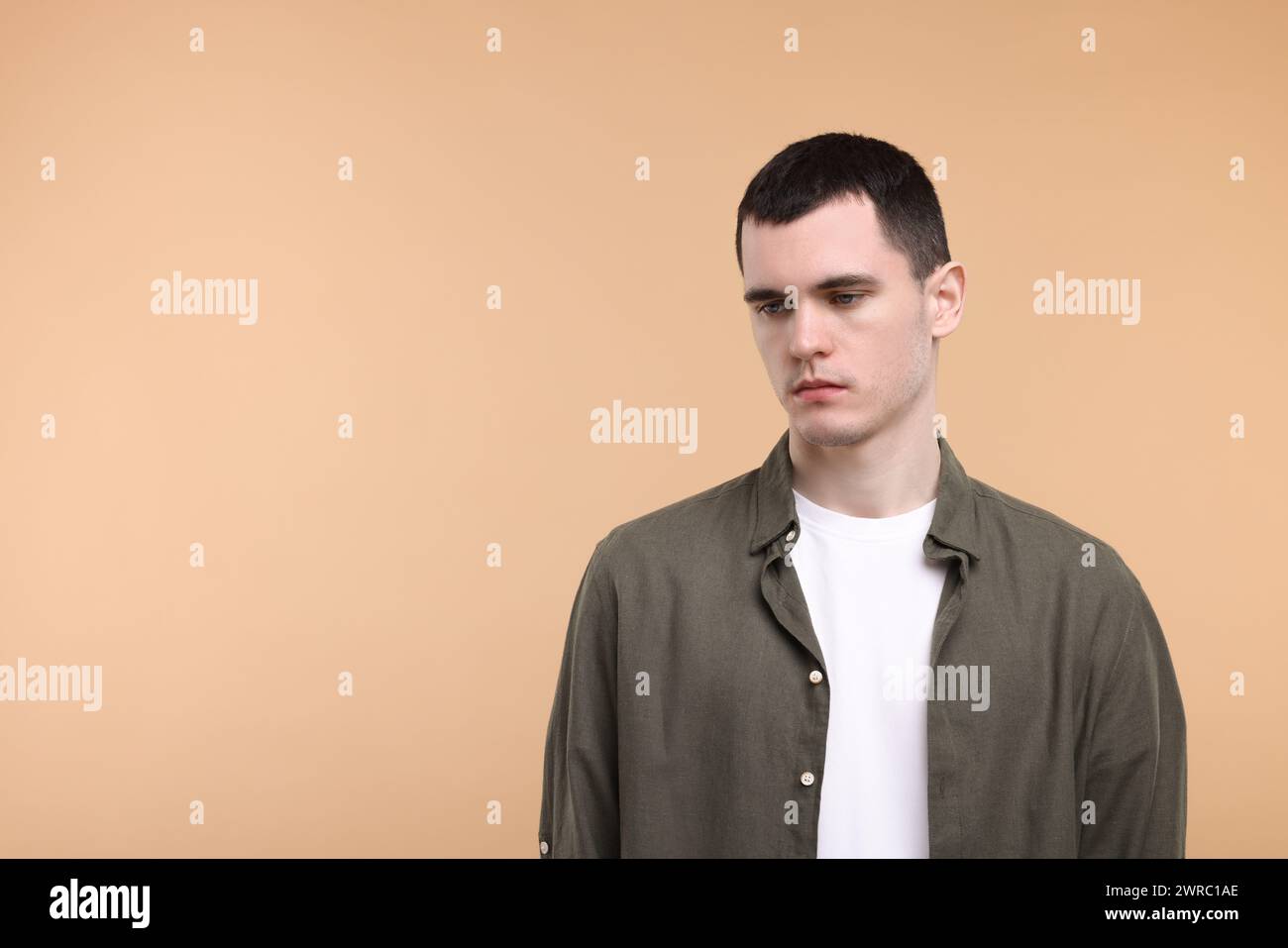 Portrait of sad man on beige background, space for text Stock Photo - Alamy