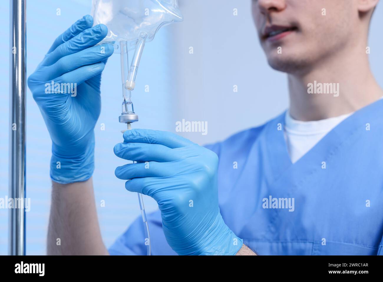 Nurse setting up IV drip in hospital, closeup Stock Photo - Alamy