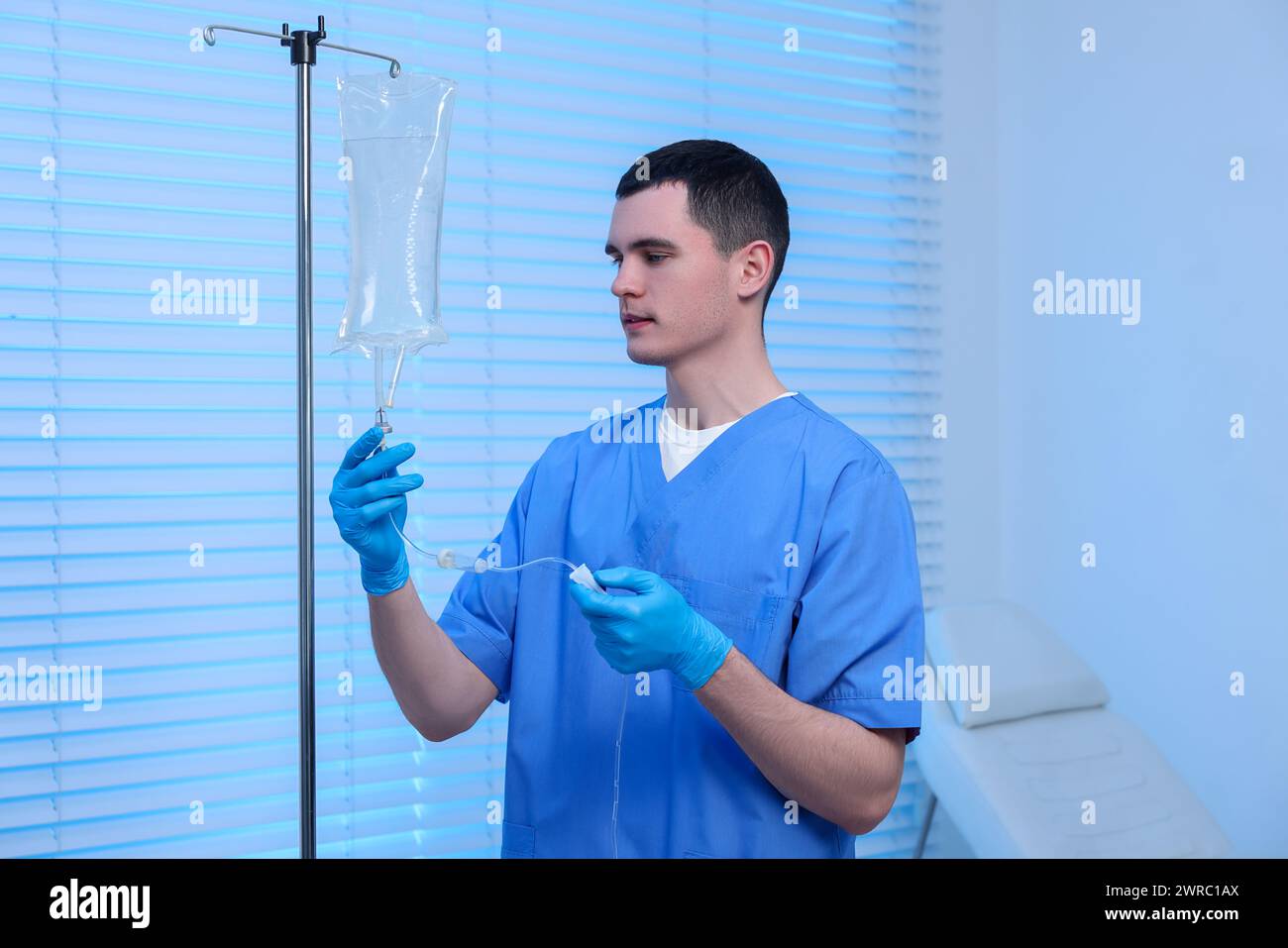 Nurse setting up IV drip in hospital Stock Photo - Alamy