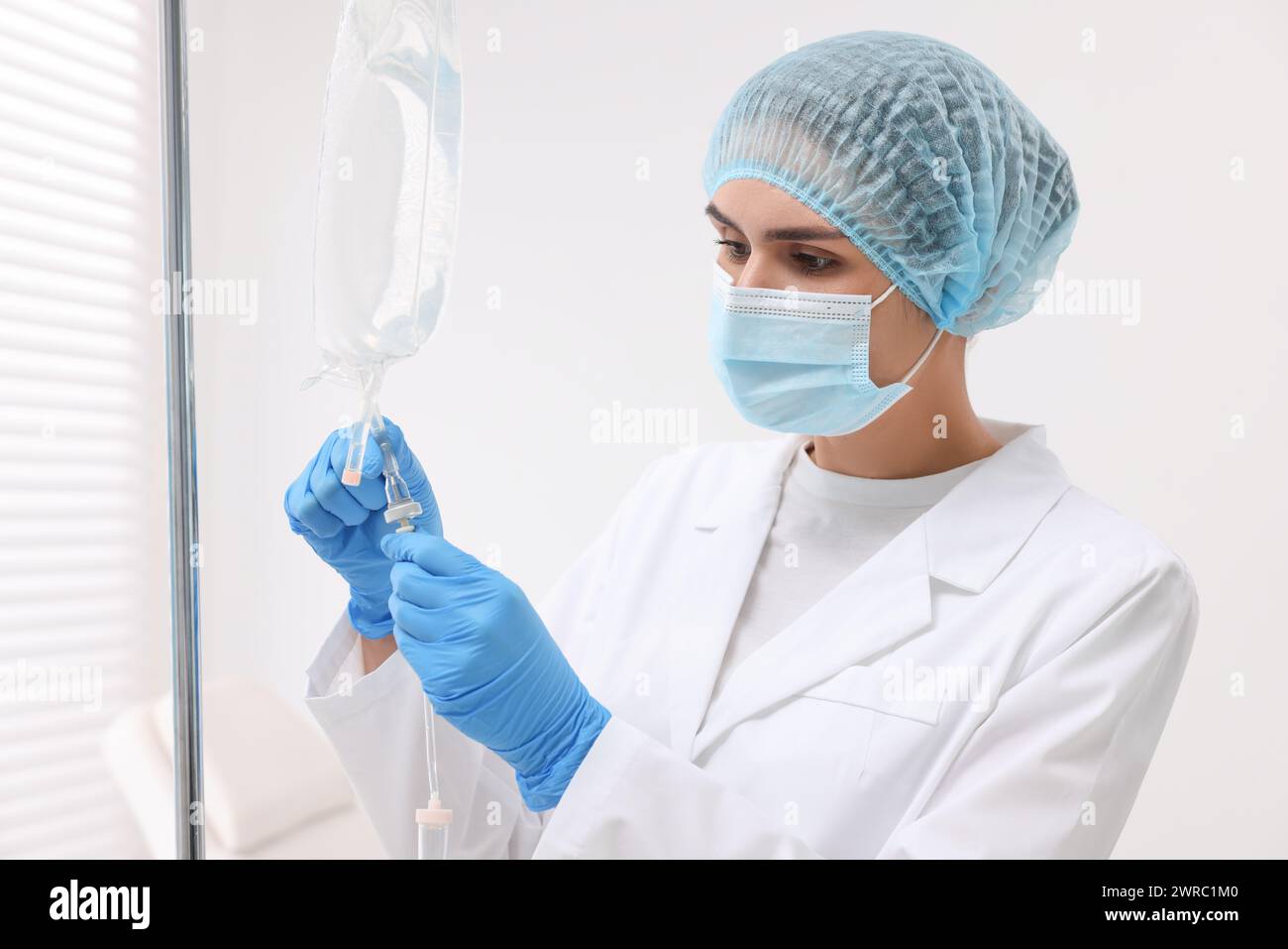 Nurse setting up IV drip in hospital Stock Photo - Alamy