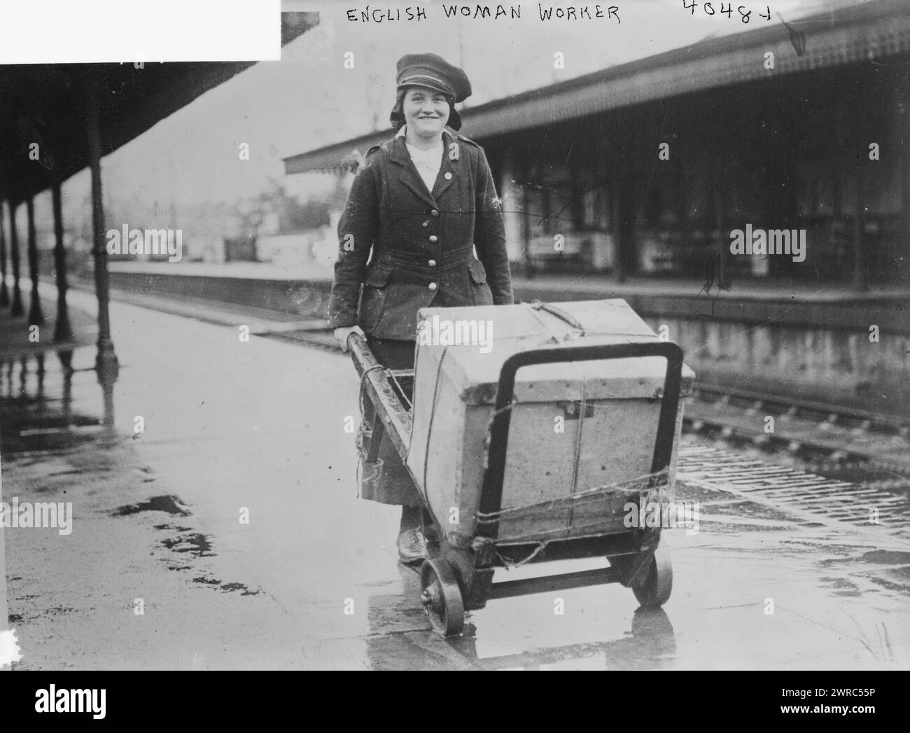 English woman worker, Photograph shows a woman worker pushing a box on ...