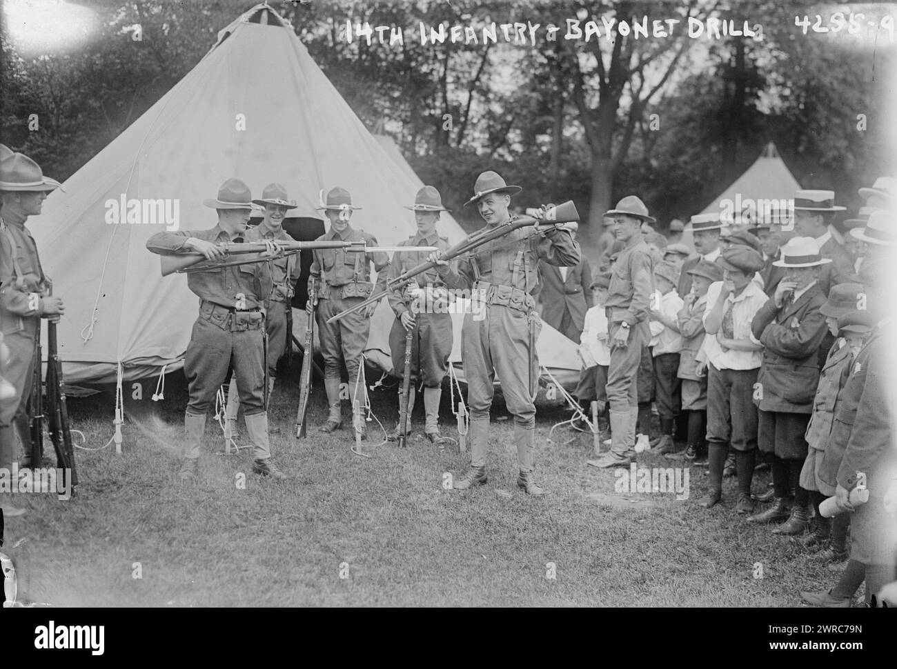 14th Infantry, Bayonet drill, Photograph shows men, women and children watching soldiers of the ...