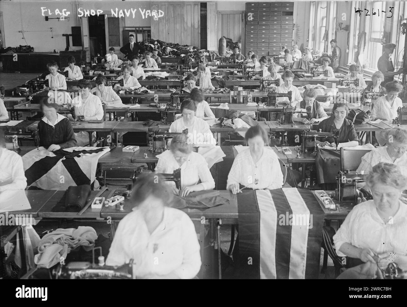 Flag shop, Navy Yard, Photograph shows women sewing flags on sewing ...
