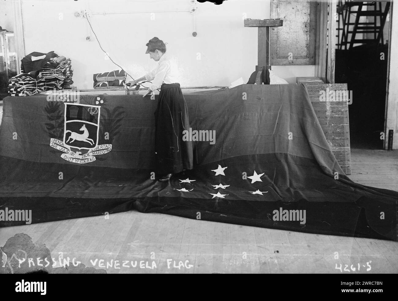 Pressing Venezuela flag, Photograph shows a woman pressing a Venezuelan ...