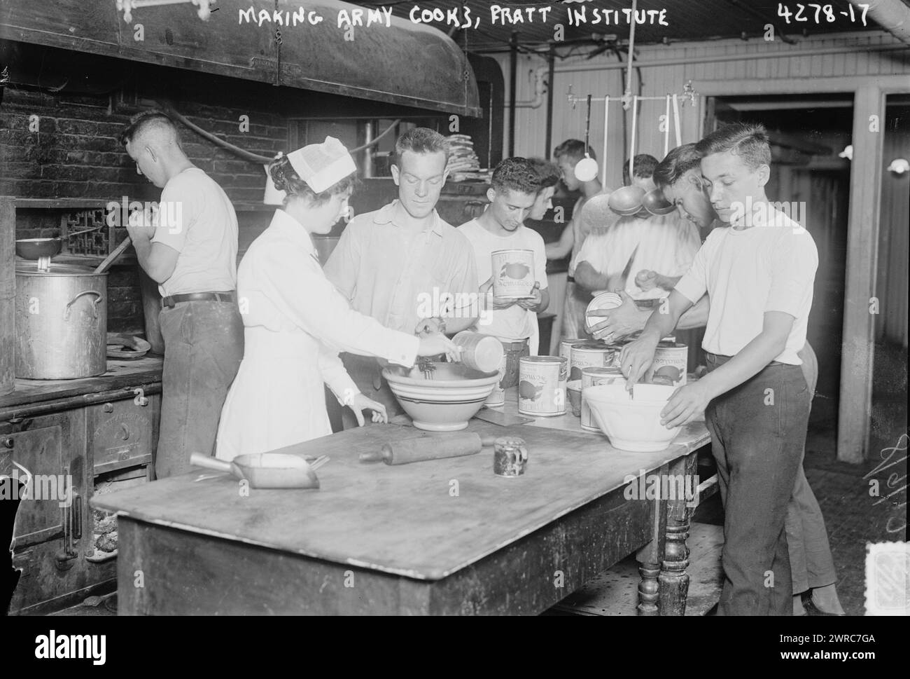 Making army cooks, Pratt Institute, Photograph shows woman teaching men ...