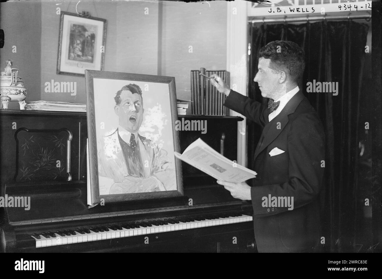 J.B. Wells, Photograph shows tenor singer and composer John Barnes Wells (1880-1935) seated at a ...
