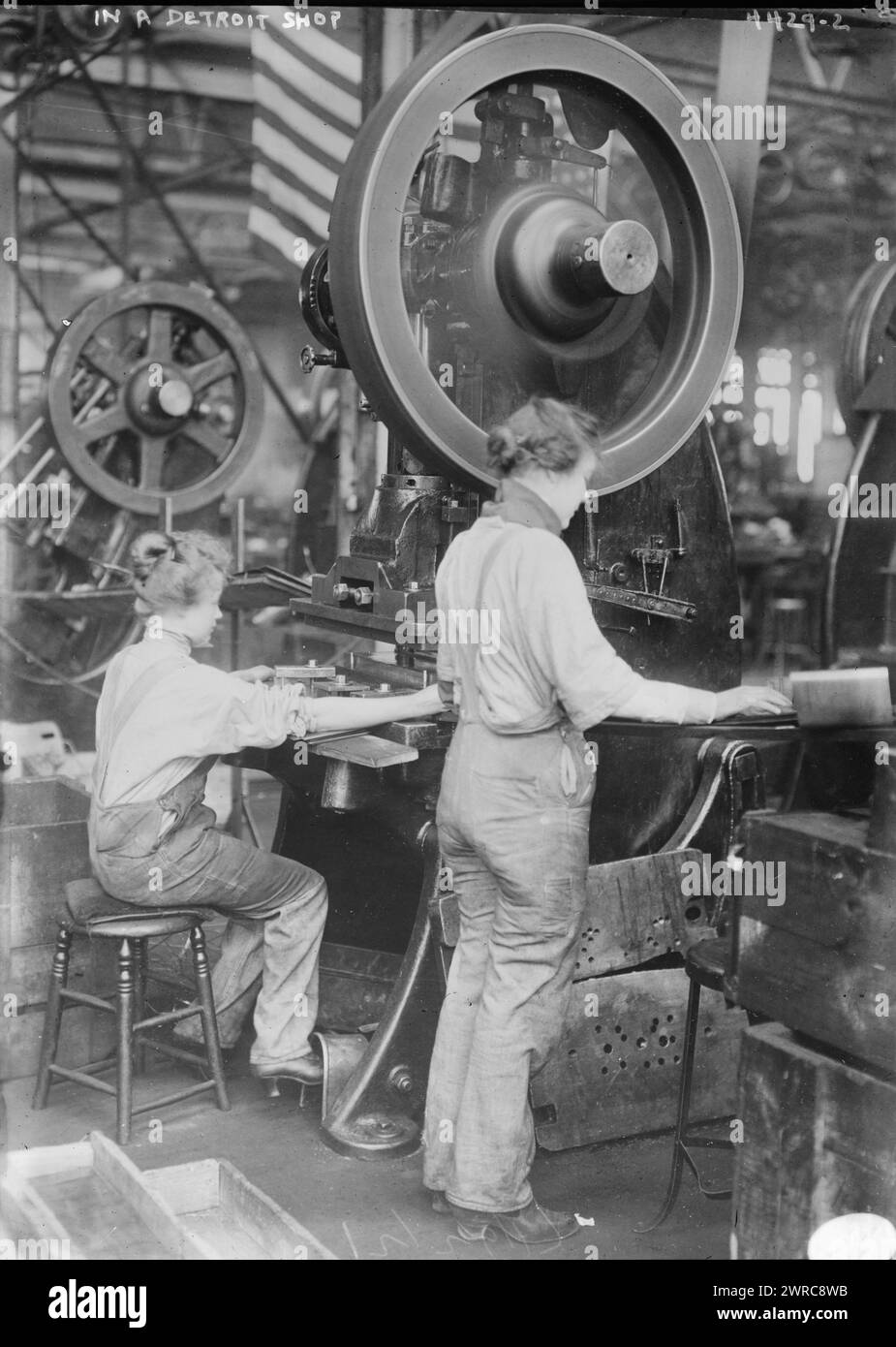 In a Detroit shop, Photograph shows two women wearing overalls as they ...