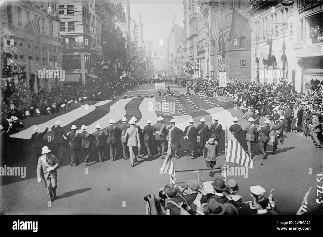 Liberty Parade, Photograph shows men with large American flag marching ...