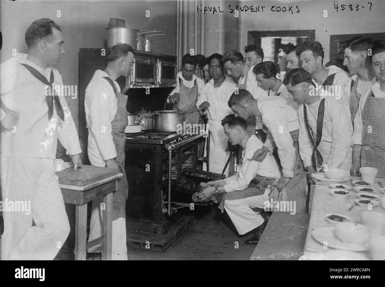 Naval student cooks, Photograph shows students at a cooking range at ...