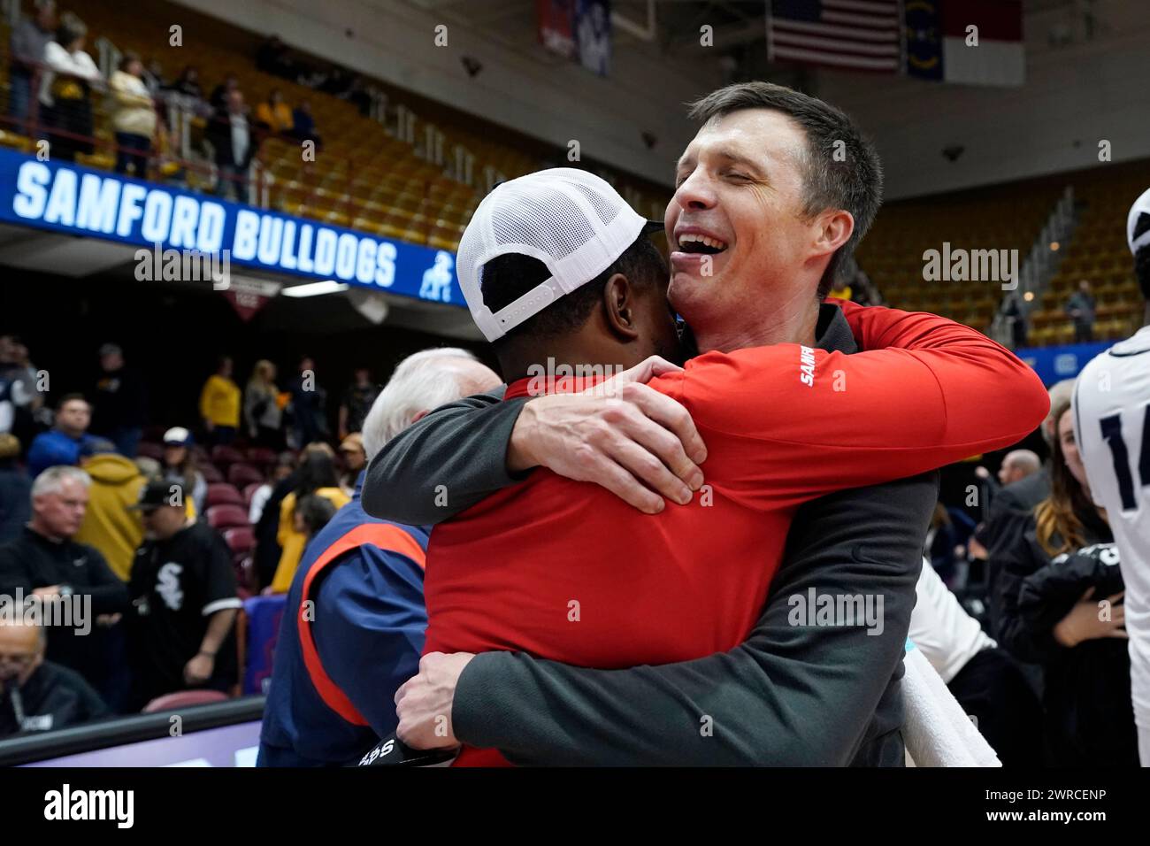 Samford head coach Bucky McMillan, right, is hugged by assistant coach ...