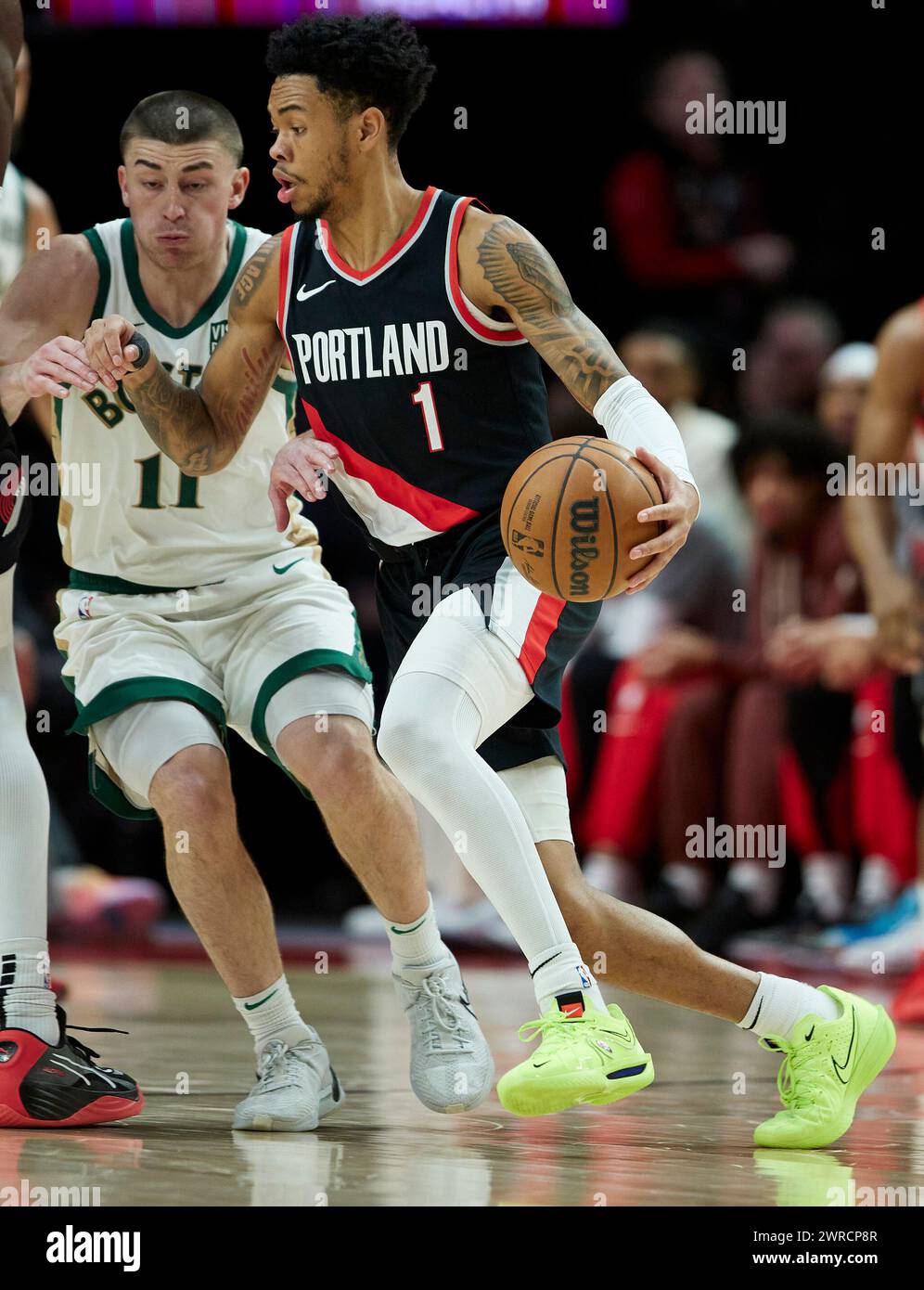 Portland Trail Blazers guard Anfernee Simons, right, dribbles around ...