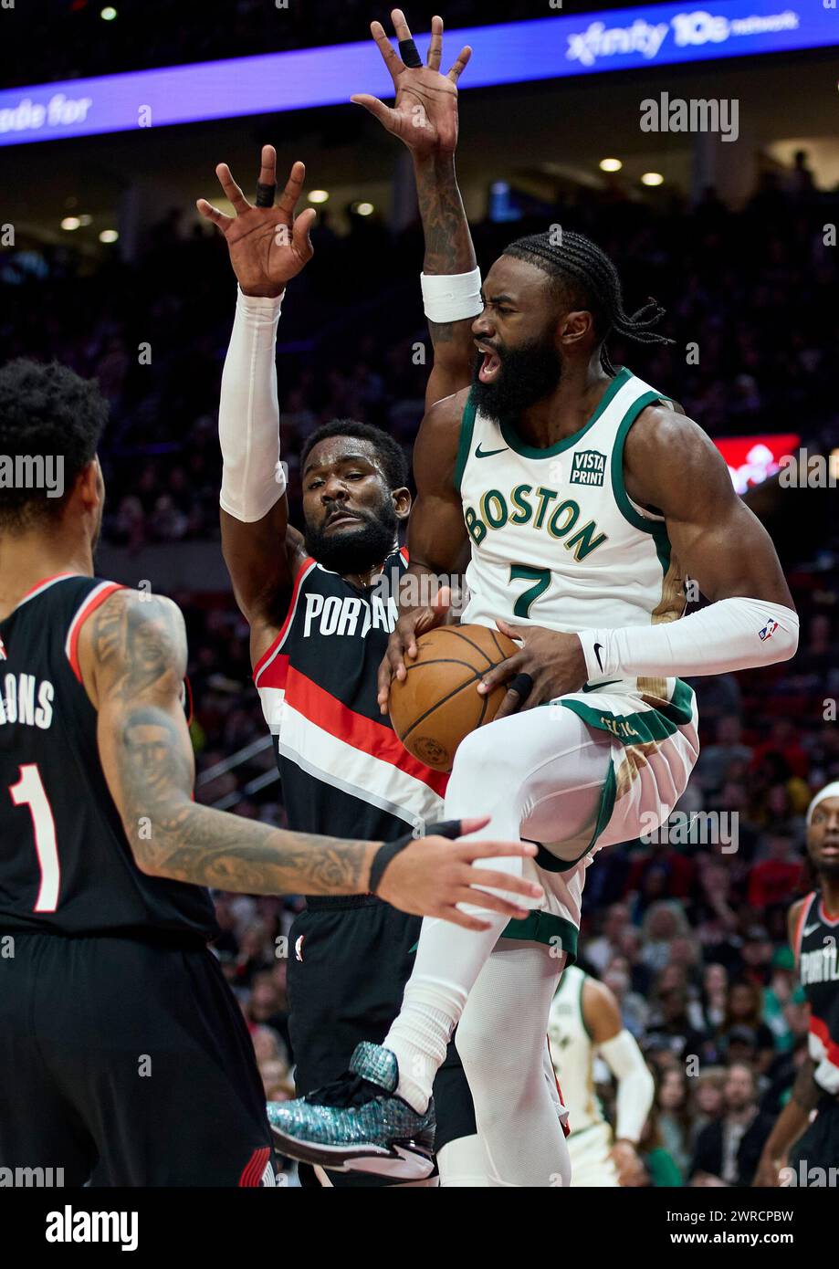 Boston Celtics guard Jaylen Brown, right, drives into Portland Trail ...