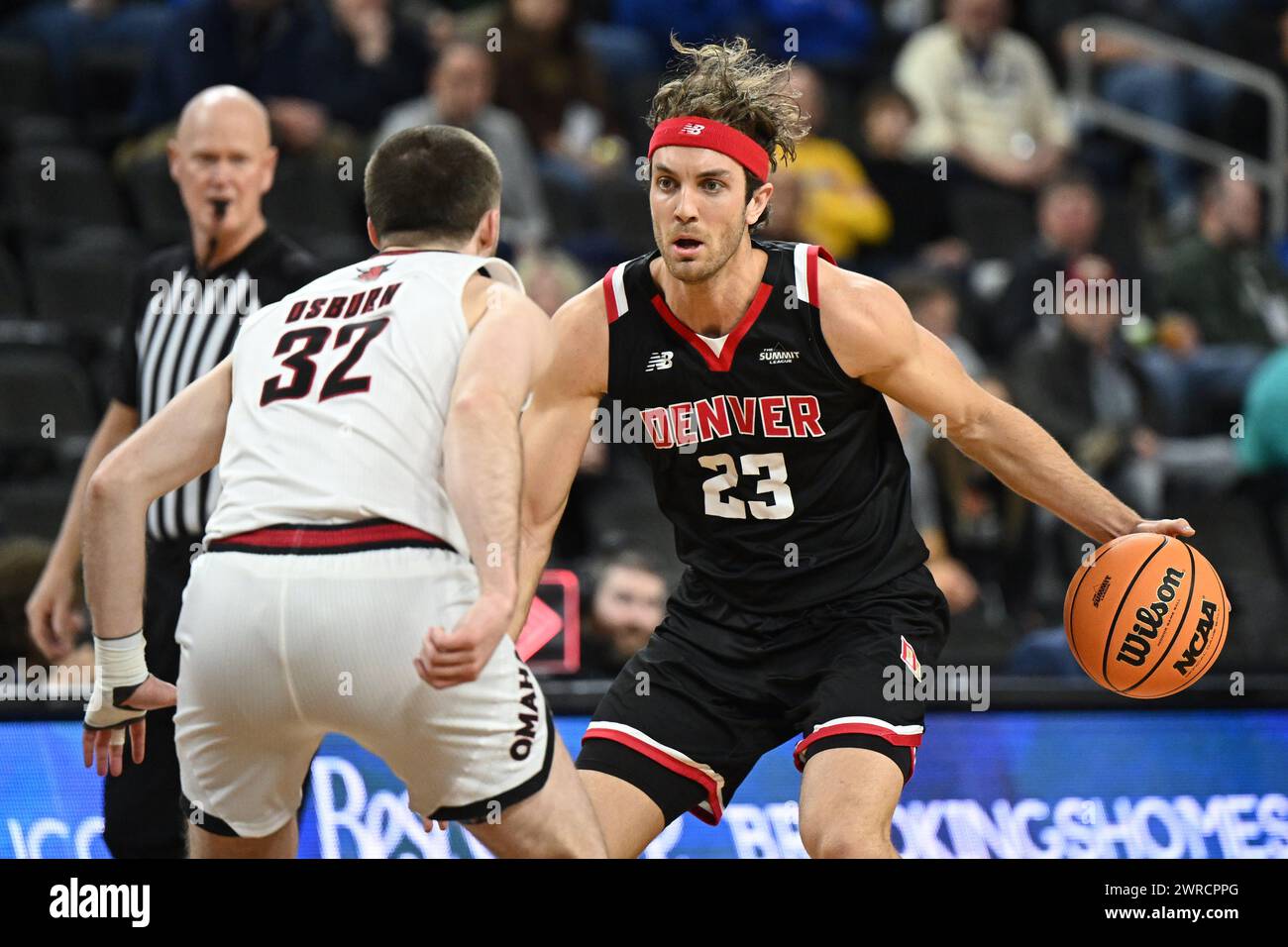 Denver Pioneers guard Isaiah Addo-Ankrah (32) guards a driving Nebraska ...