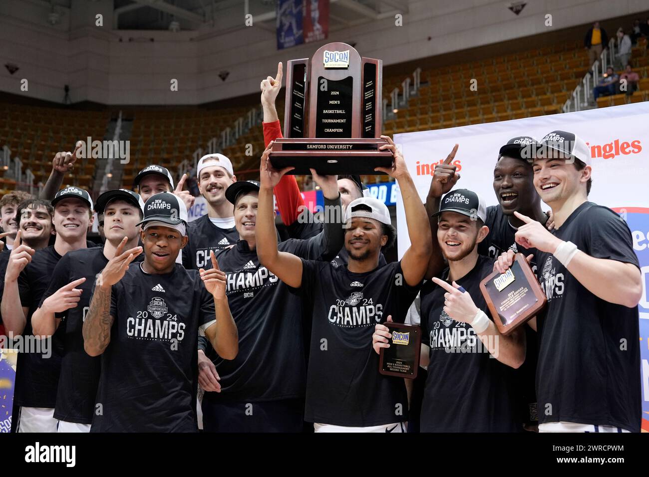 Samford guard Garrett Hicks, fourth from right, raises the championship ...