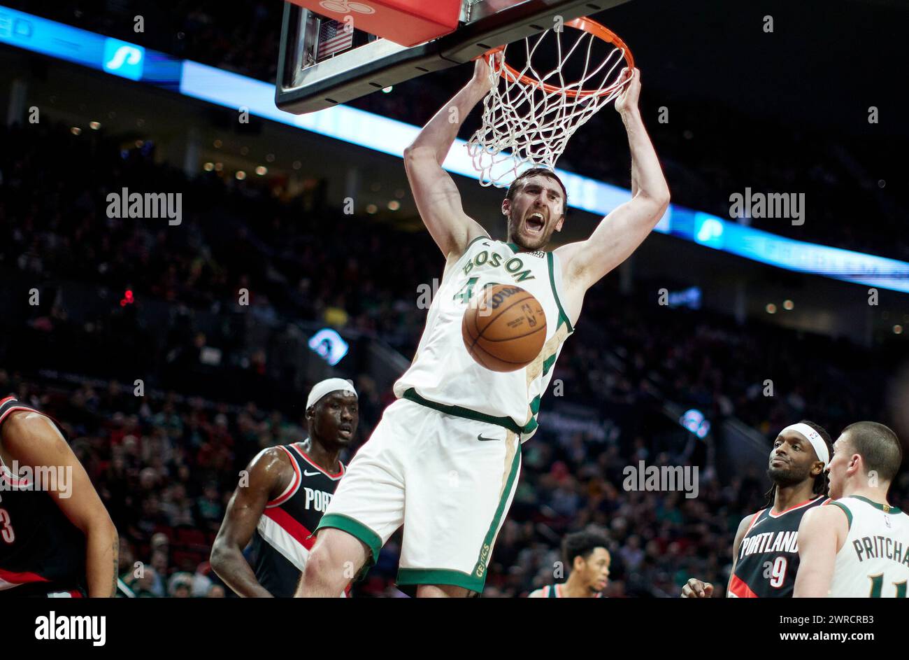 Boston Celtics center Luke Kornet, center, dunks against the Portland ...