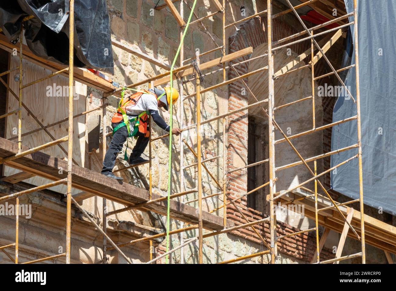 Oaxaca, Mexico - A worker on scaffolding on a project repairing the ...