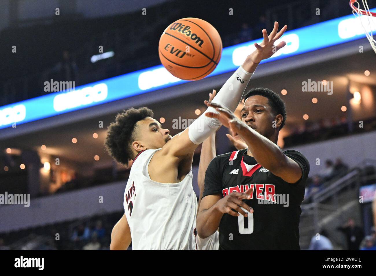 Denver Pioneers guard Tommy Bruner (0) dishes off a pass under the ...