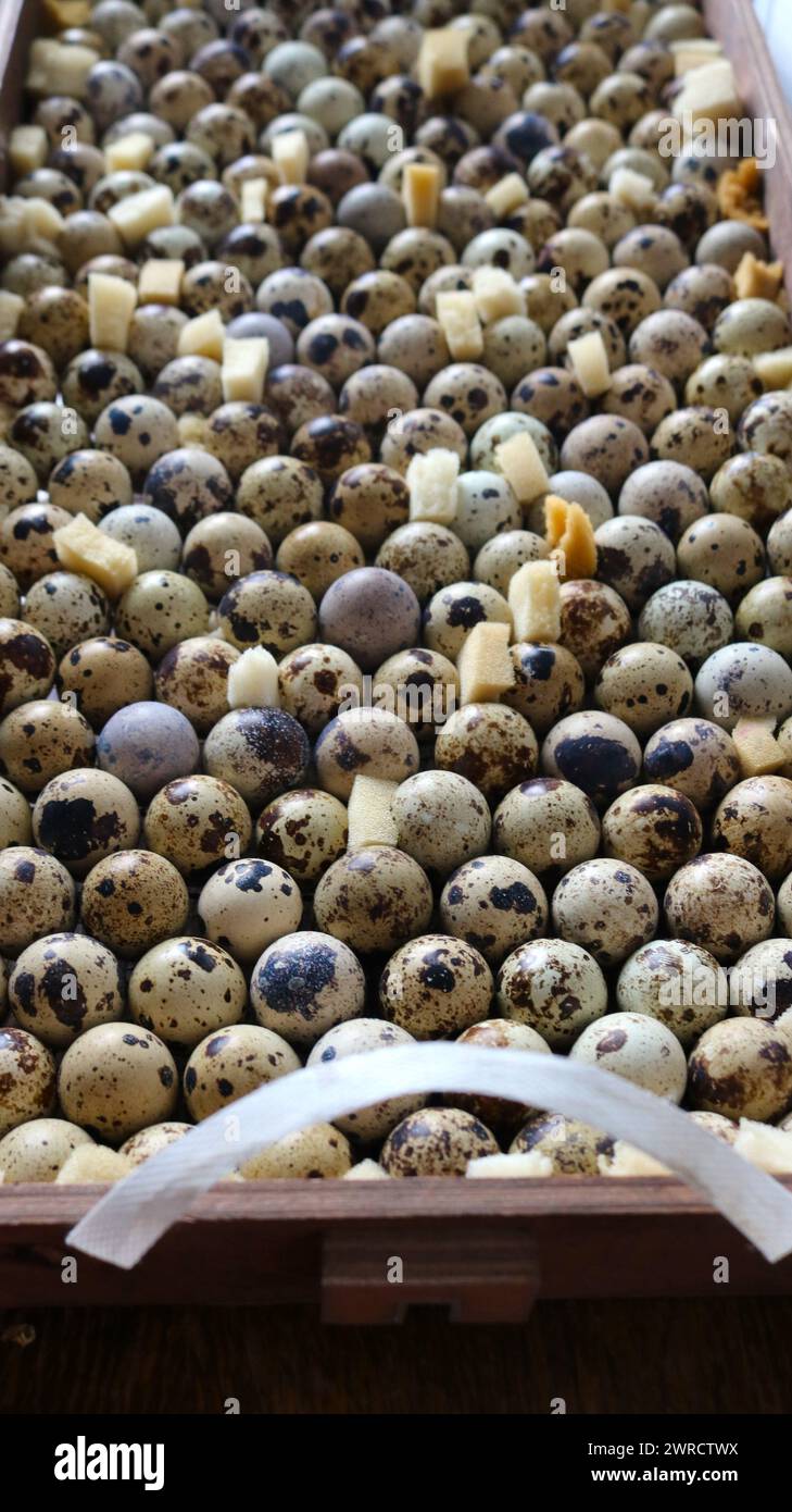Vertical photo of the pallet filled with quail eggs for incubation at ...