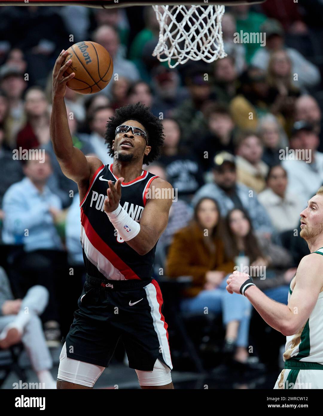 Portland Trail Blazers guard Scoot Henderson, left, shoots over Boston ...