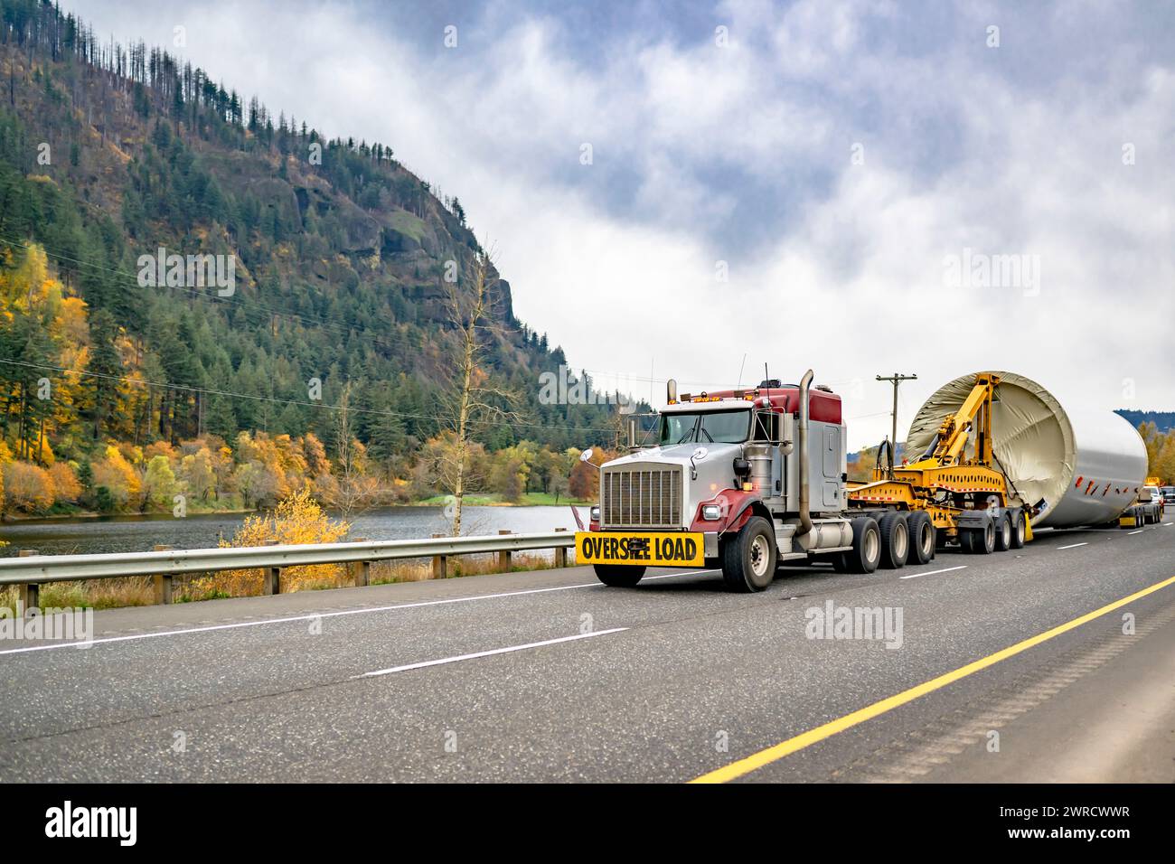 Industrial carrier big rig semi truck with oversize load sign on the ...