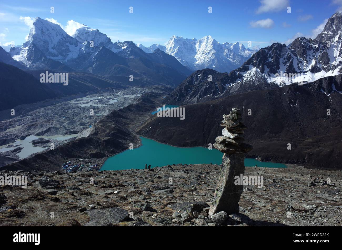 Hiking in Nepal Himalayas, Stone pyramid on Gorio Ri with view of Gokyo ...