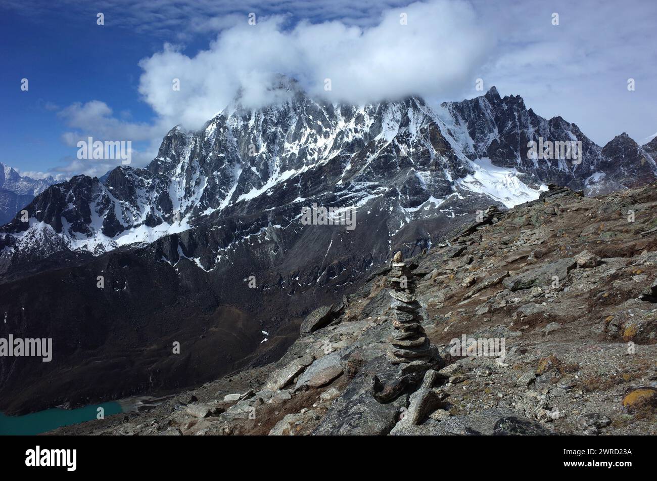 Hiking in Nepal Himalayas, Stone pyramid with view of Pharilapche ...