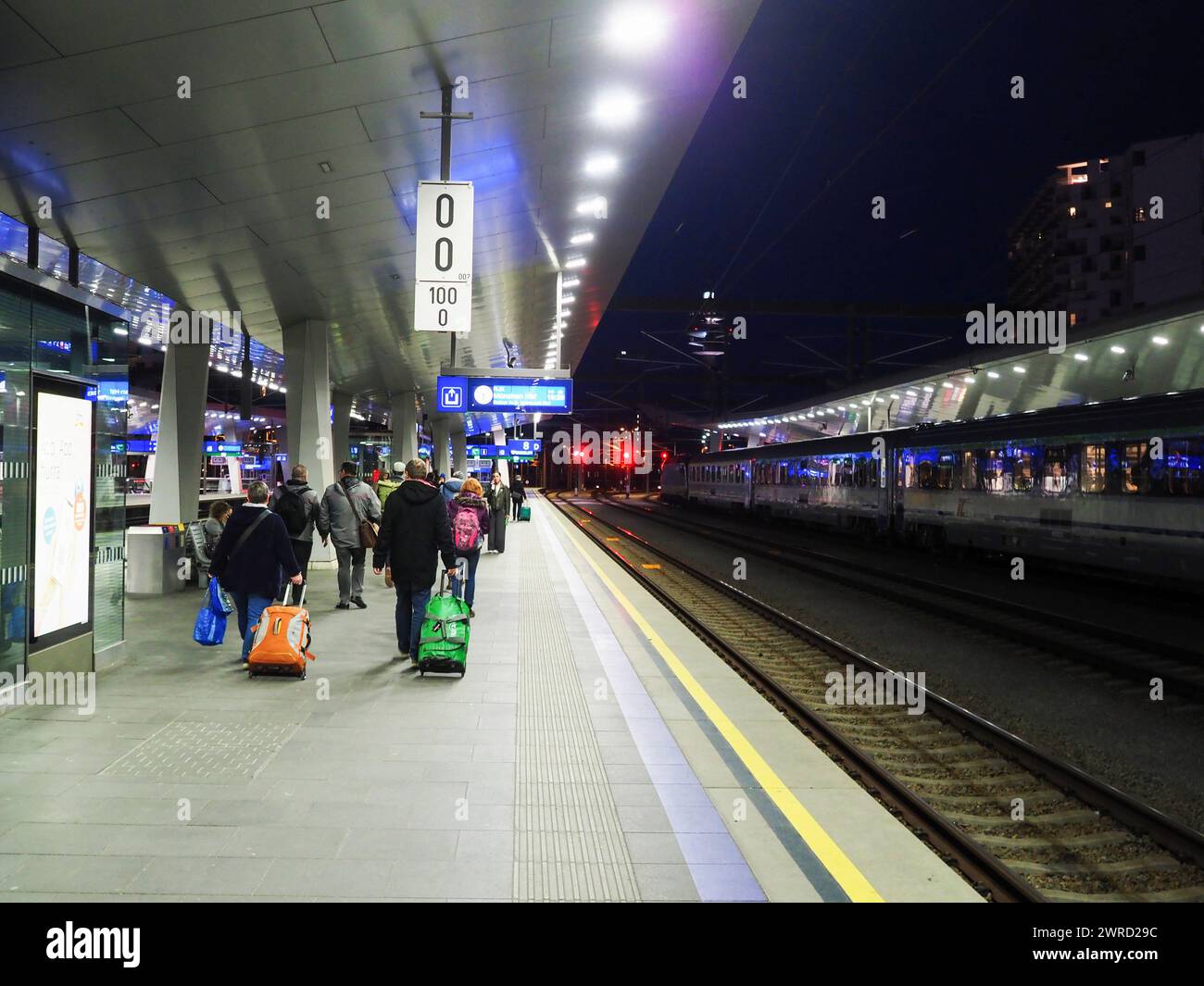 Passengers await the arrival of a train at Vienna Central Station Stock ...