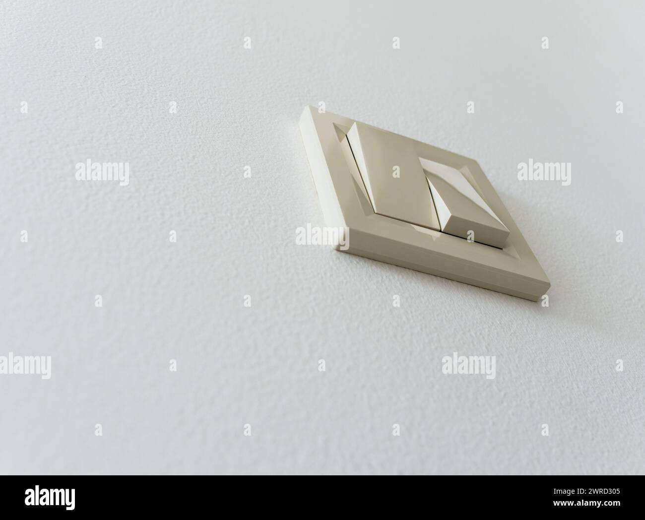 Diagonal view of an electrical switch on a white wall Stock Photo - Alamy