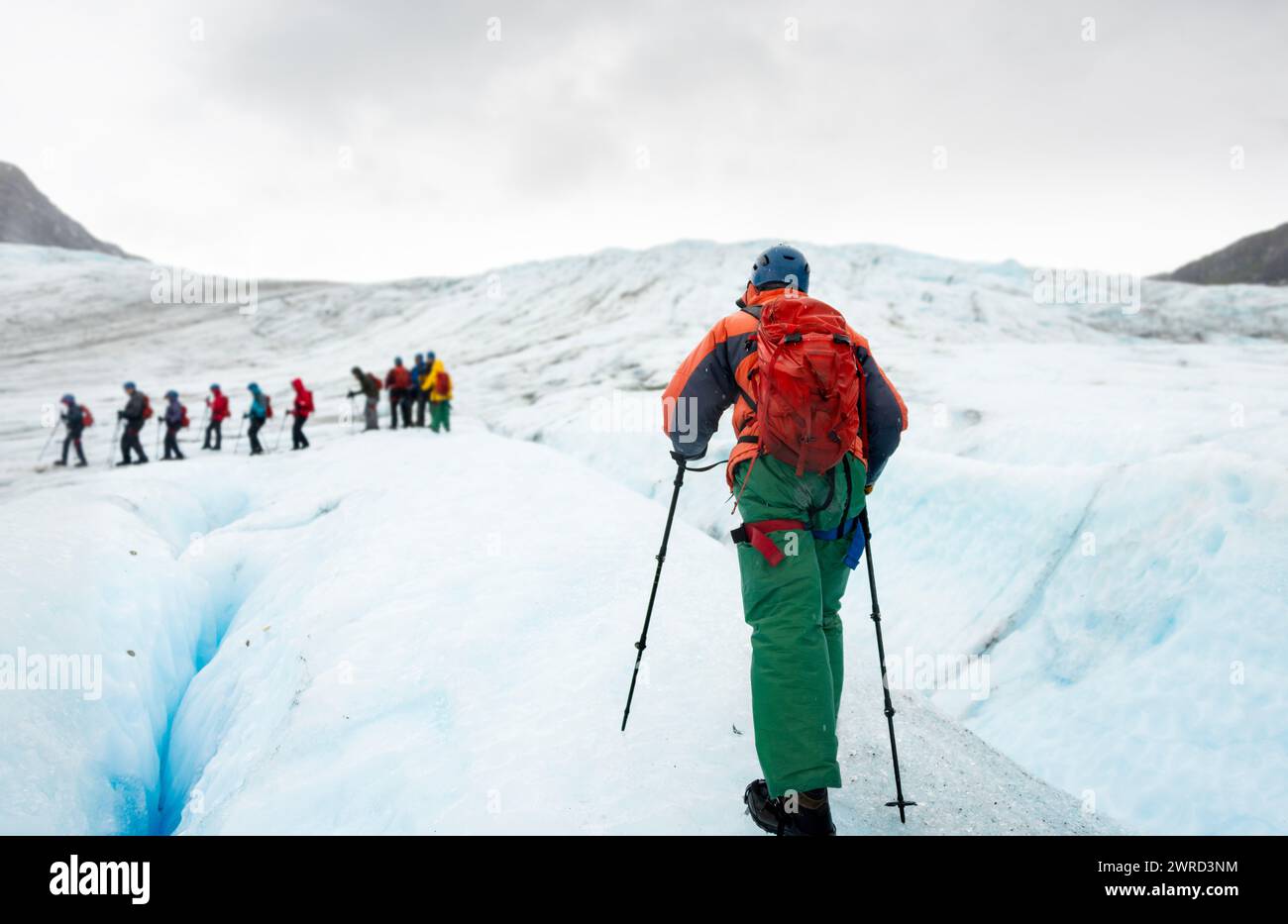 Exit Glacier ice hiking. People wearing ice crampons and walking on ...