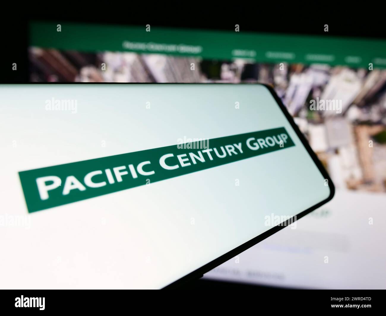 Mobile phone with logo of investment company Pacific Century Group (PCG ...