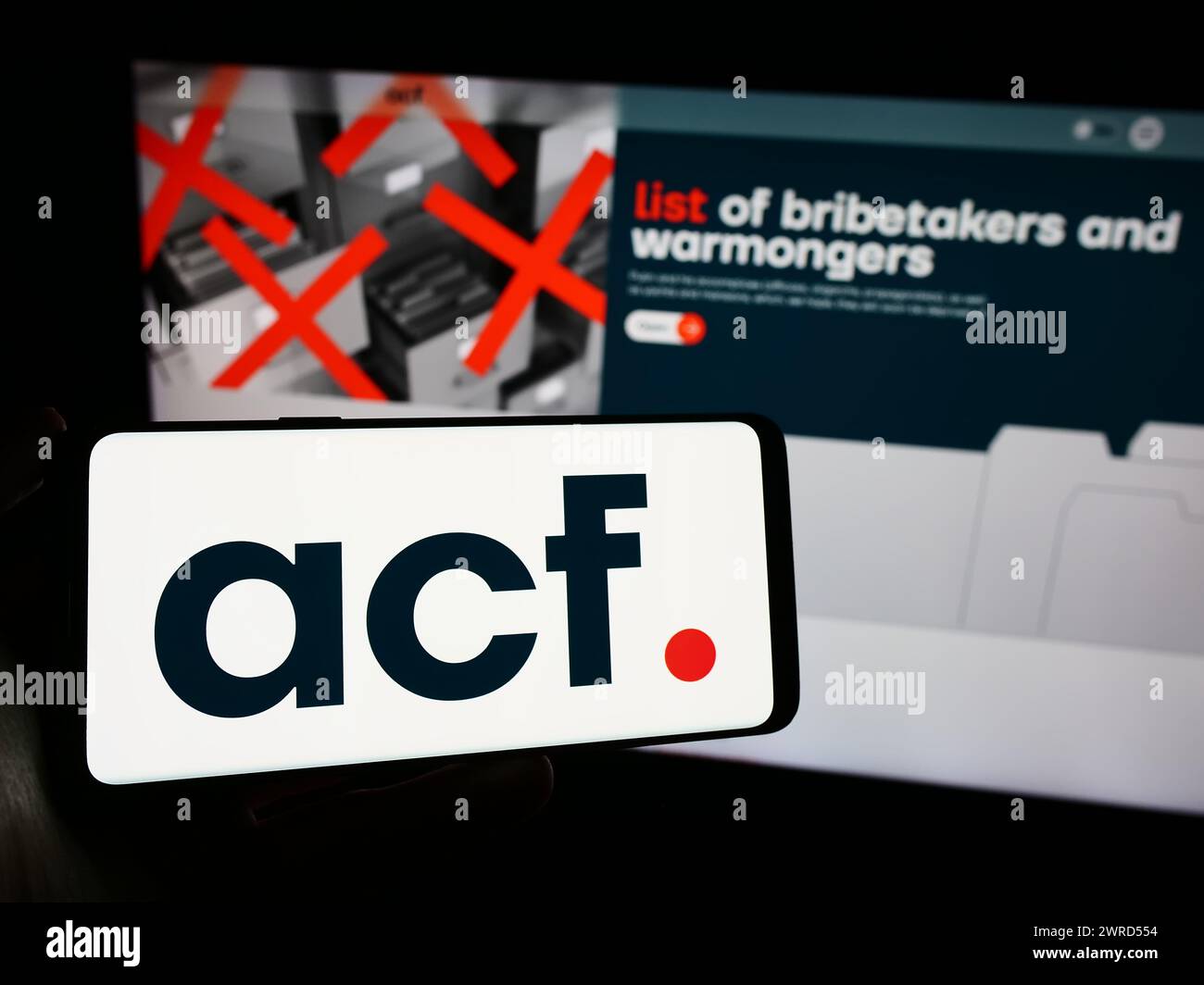 Person holding cellphone with logo of Russian organisation Anti ...