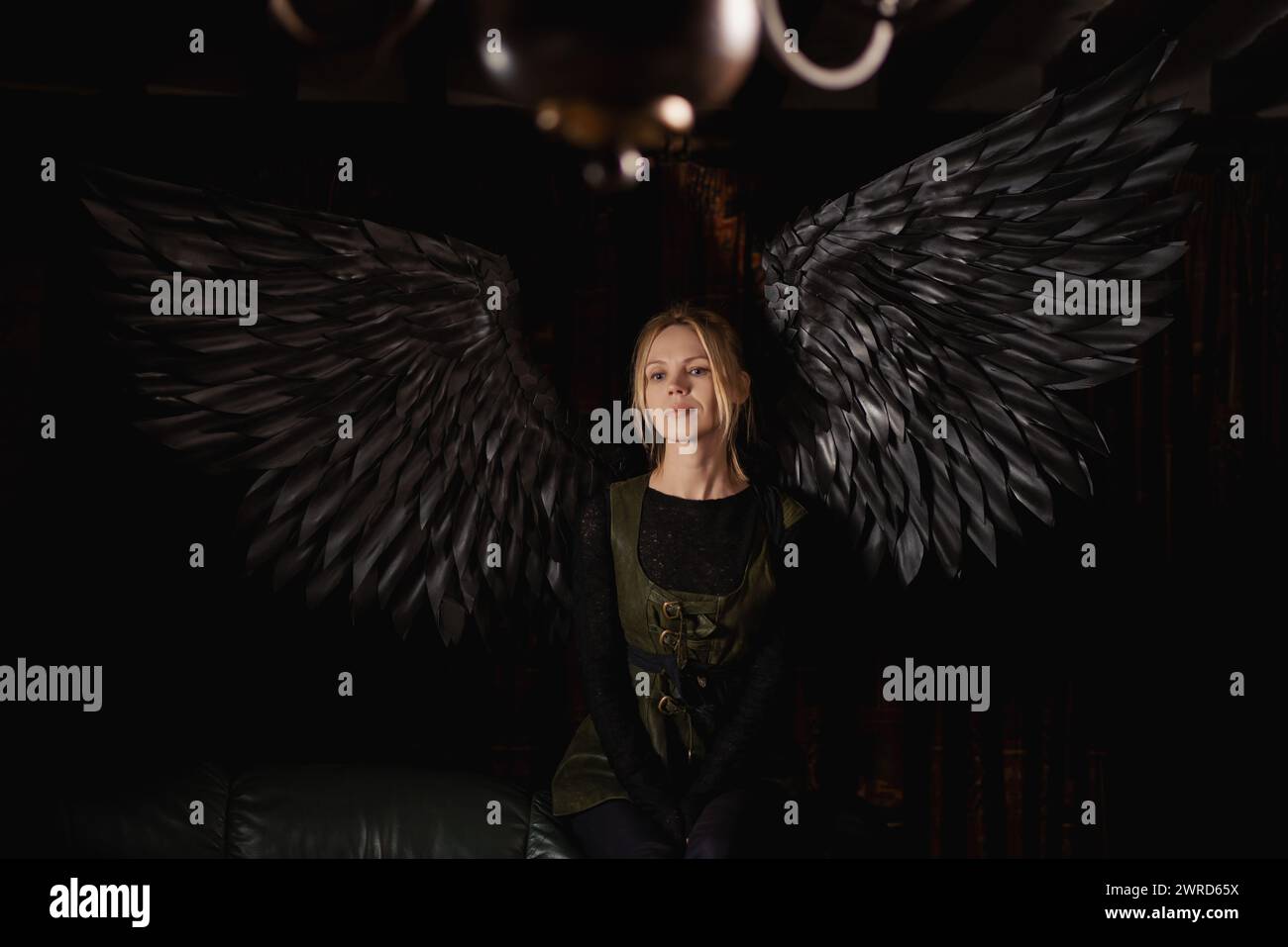 A woman with black angel wings is a fallen angel, cast out of heaven ...