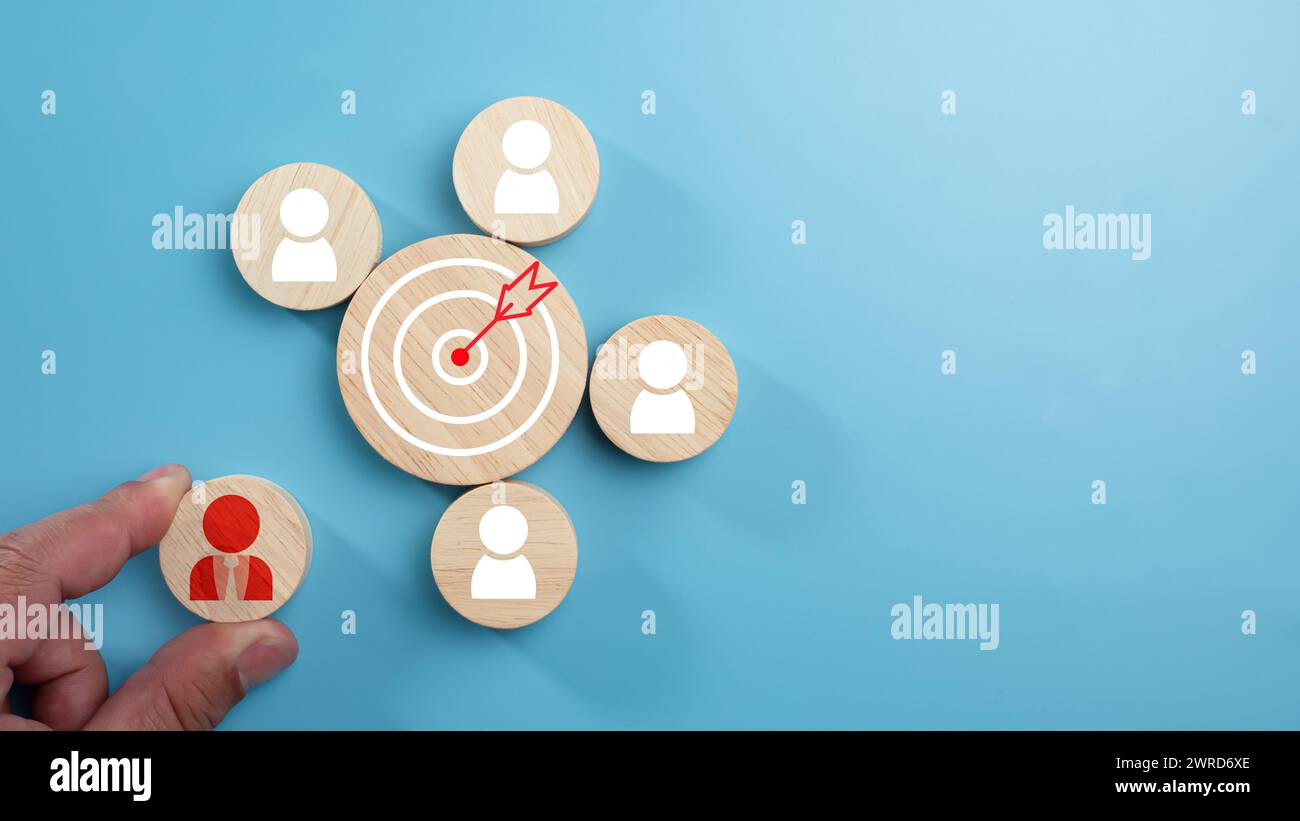 Circular wood with printed target icons and business symbols on light ...