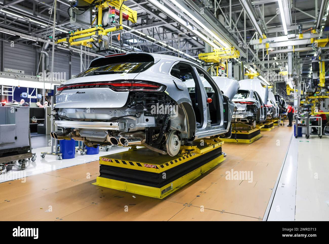11 March 2024, Saxony, Leipzig: Porsche Macan driving through the ...