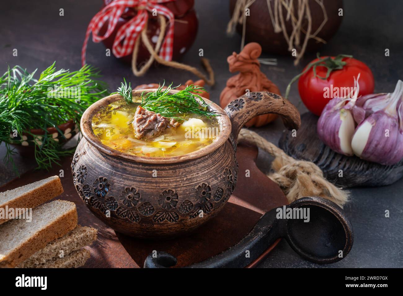 cabbage soup in a clay pot. Traditional Russian soup of sauerkraut and ...
